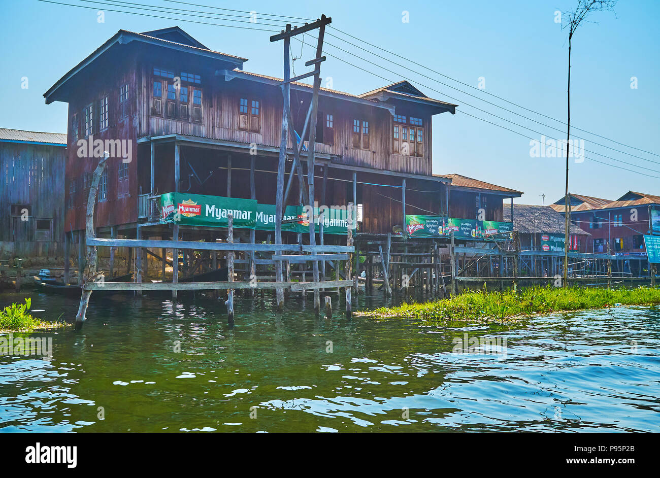INLE LAKE, MYANMAR - FEBRUARY 18, 2018: The row of old stilt houses of ...