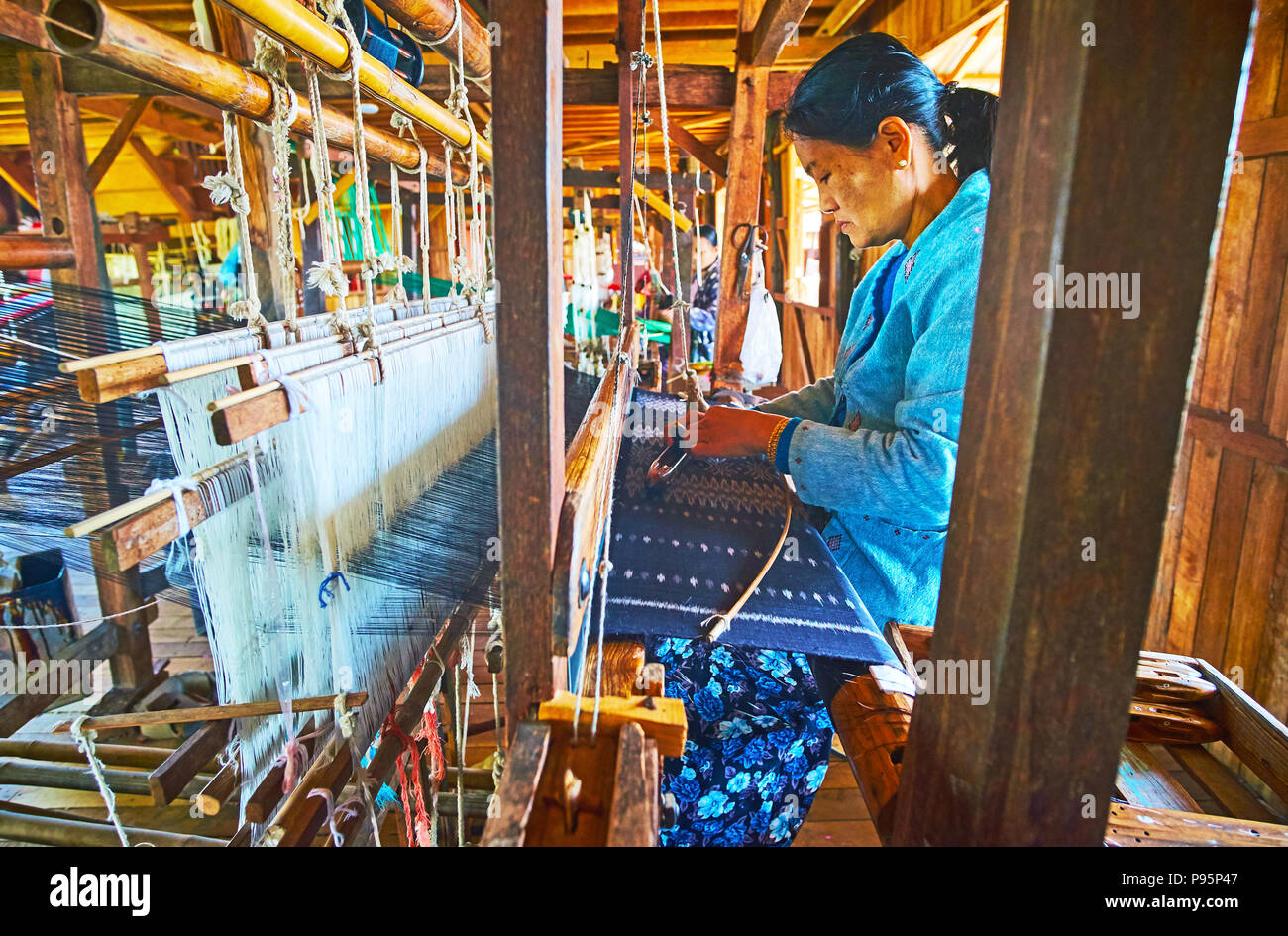 INLE LAKE, MYANMAR - FEBRUARY 18, 2018: Producing of silk textile on ...