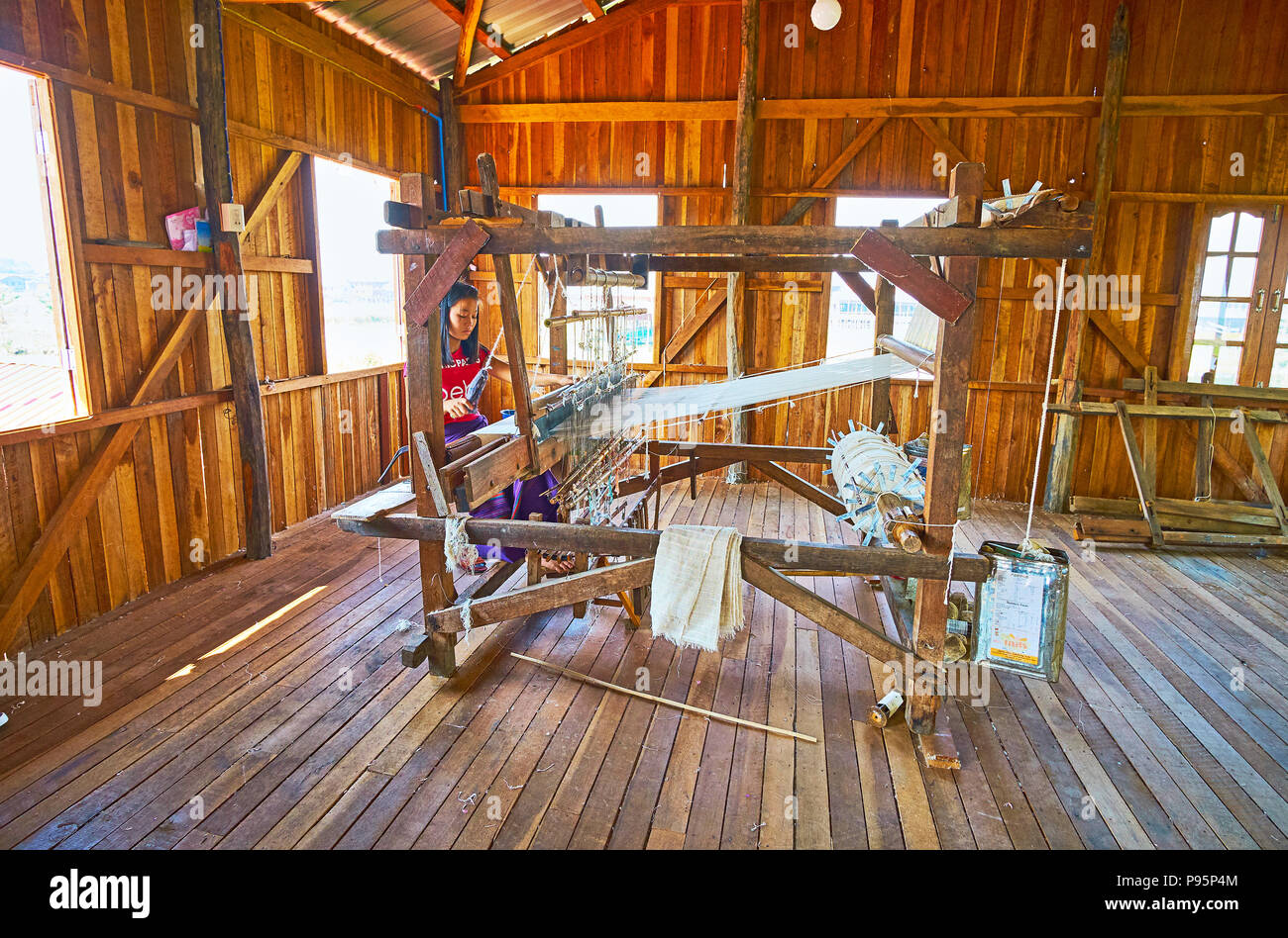 INPAWKHON, MYANMAR - FEBRUARY 18, 2018: The young girl produces the ...