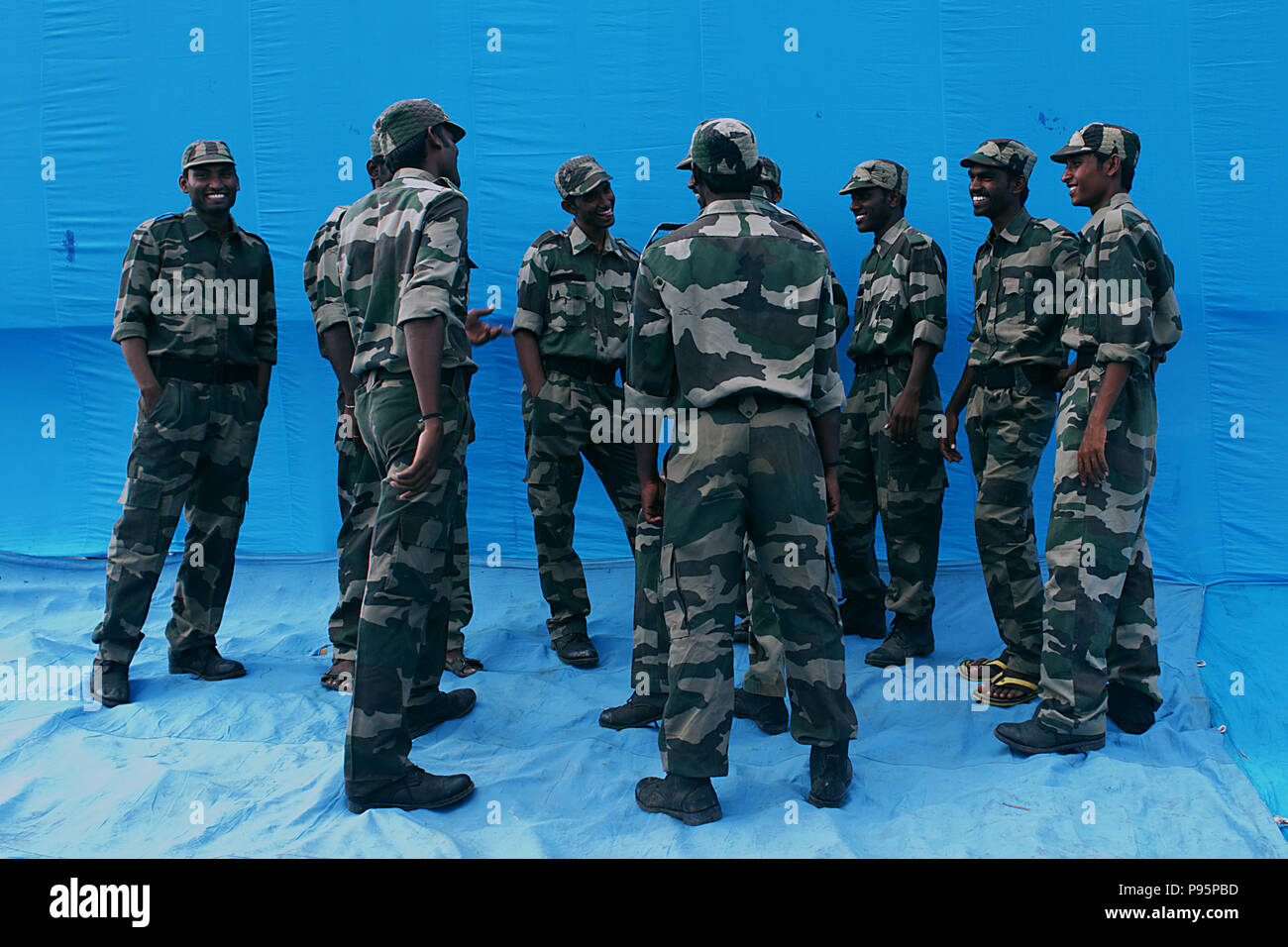 Group of military soldiers standing, blue screen background Stock Photo ...