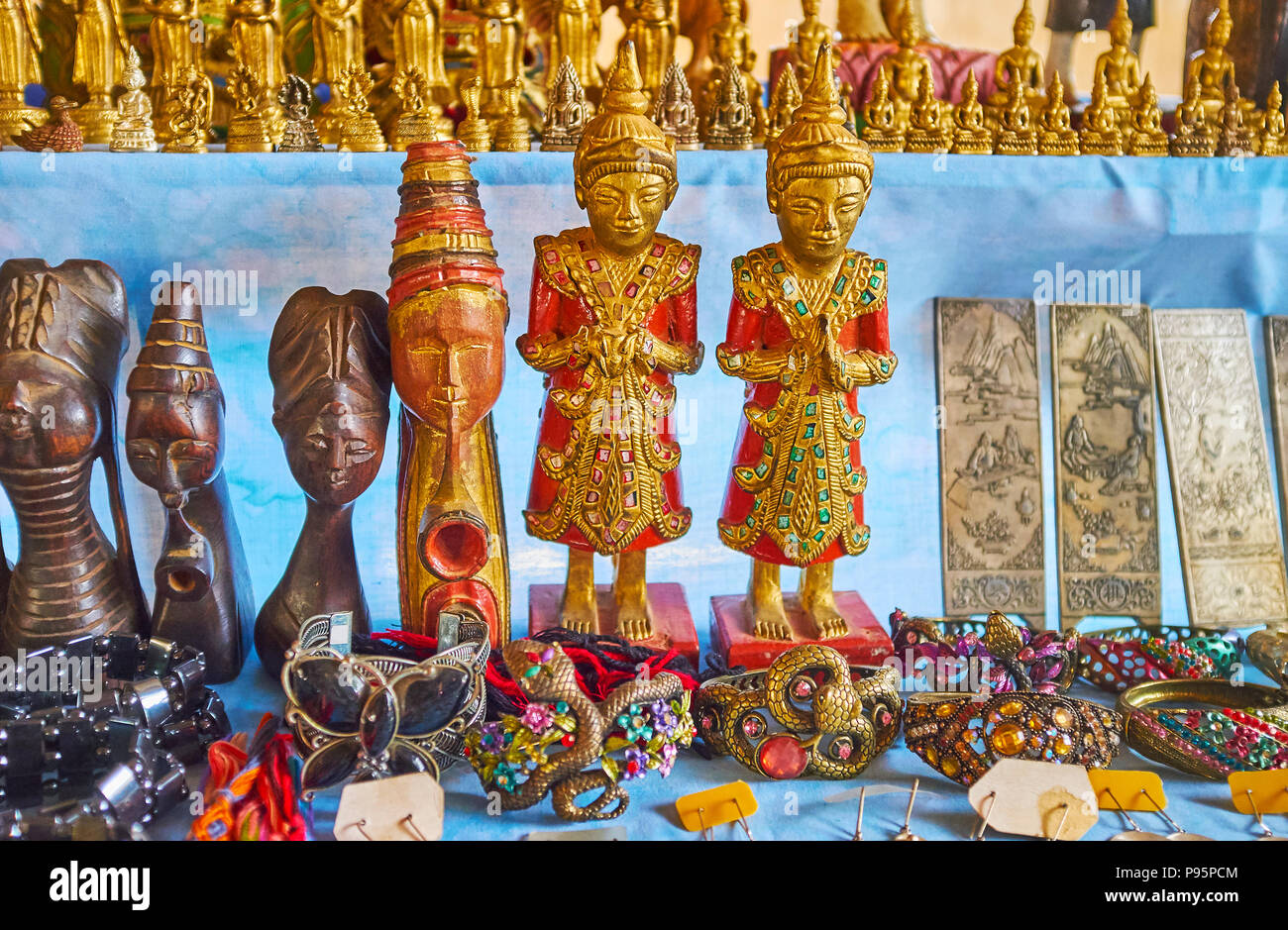 The handmade carved wooden souvenirs on counter of market stall in old ...
