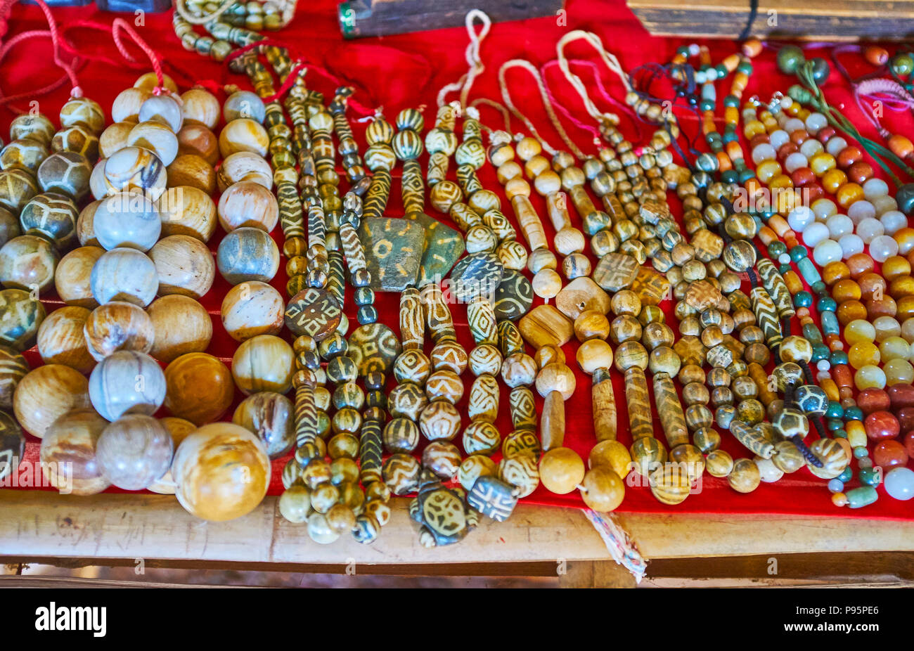 Traditional stone beads, decorated with ancient tribal patterns are ...