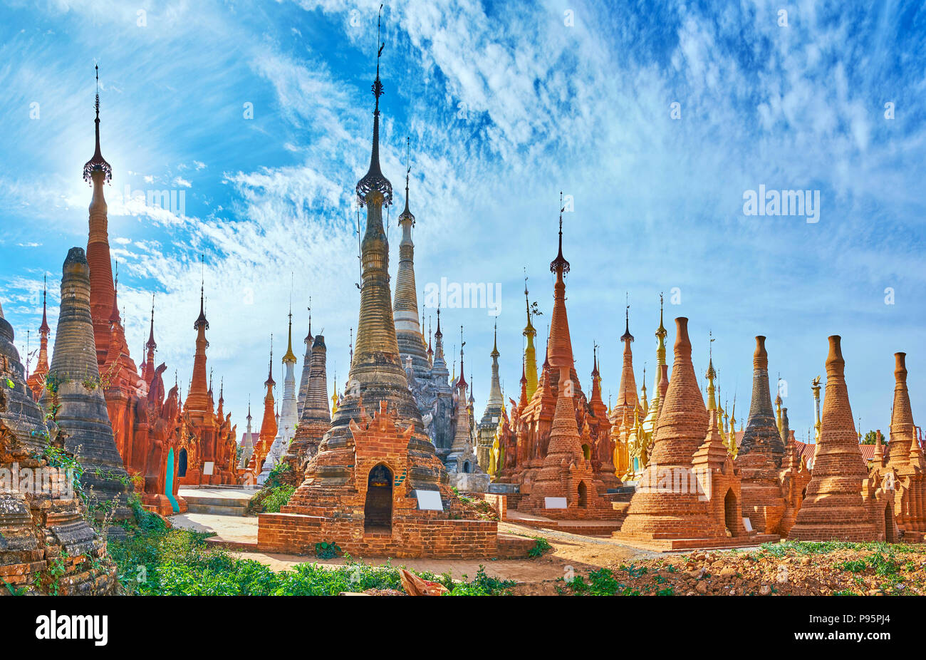 The rows of small stupas, decorated with hti decorative umbrellas and ...