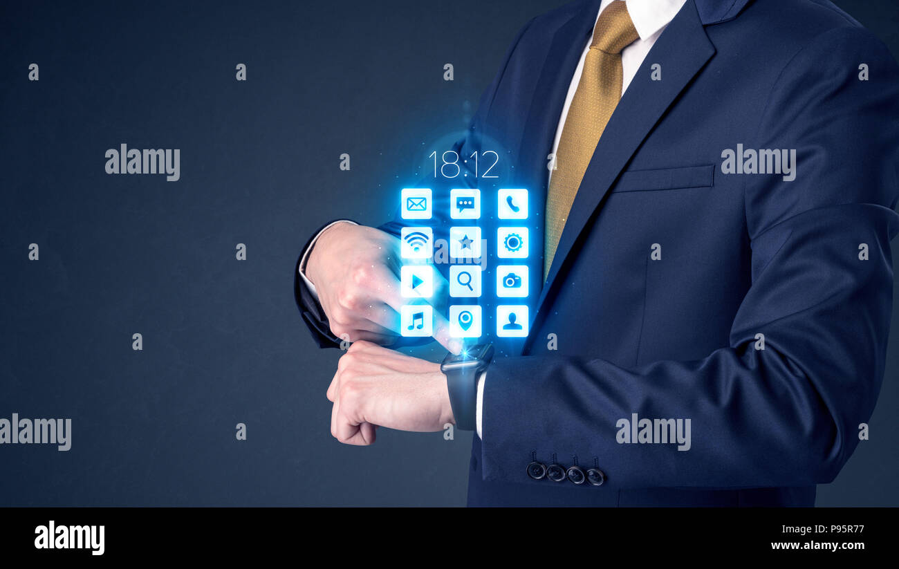 Businessman wearing smartwatch with application icons Stock Photo - Alamy
