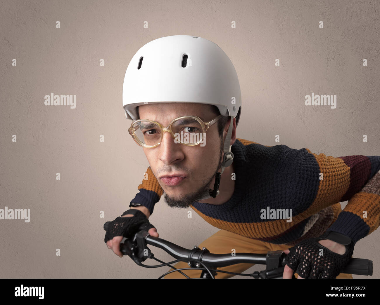 Nerd young foolish biker on a bike with oldschool outfit Stock Photo ...