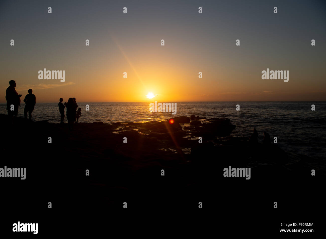 People Watching the Sunset in the Pacific Stock Photo - Alamy