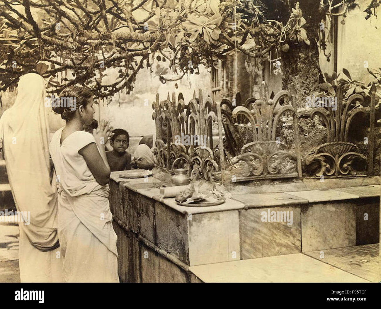A Hindu wife prays to the Siva for blessing of fertility in Calcutta in ...