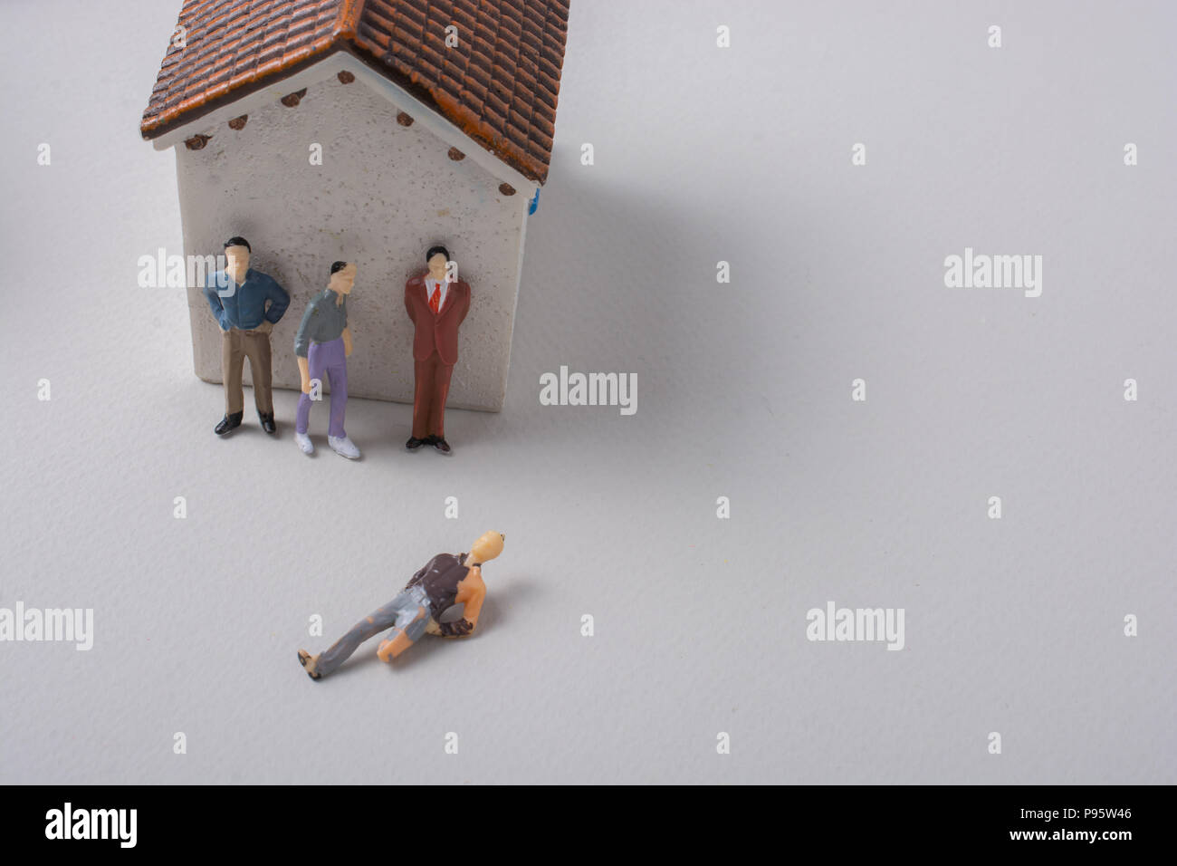 Tiny figurine of man miniature before a house Stock Photo - Alamy