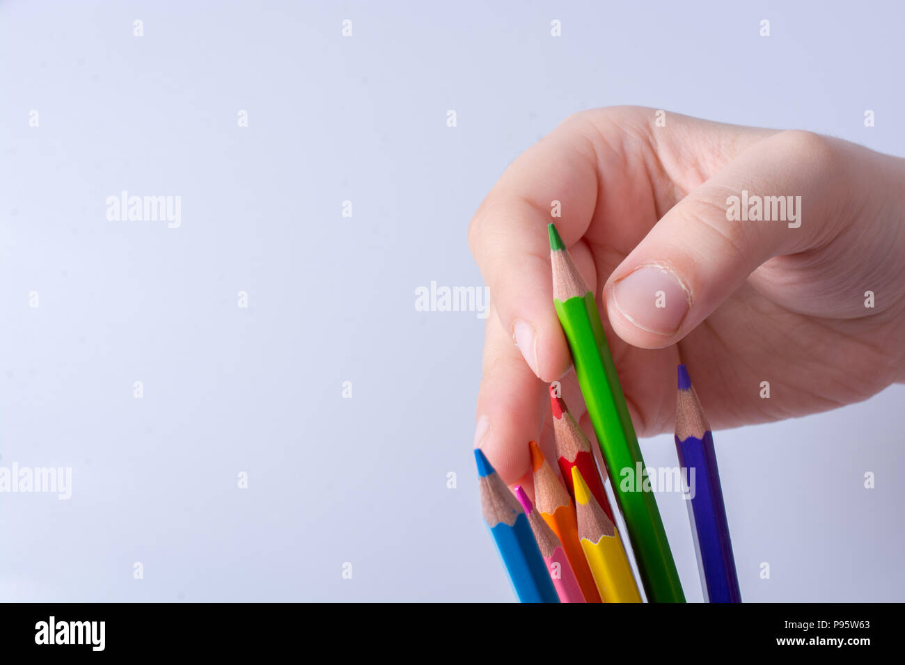Hand holding color Pencils placed on a white background Stock Photo - Alamy