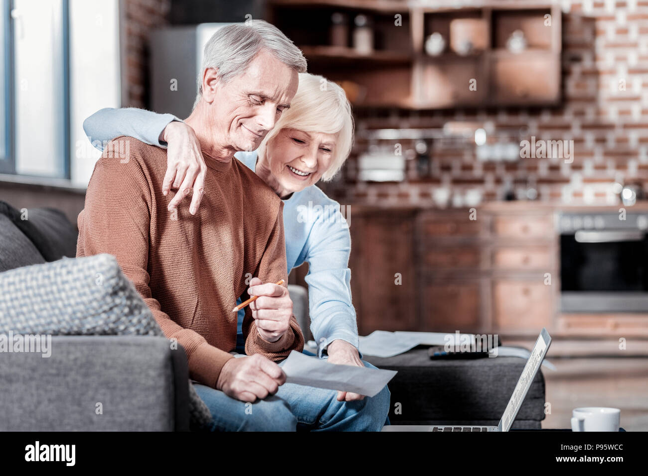 Positive delighted couple staring at computer Stock Photo - Alamy
