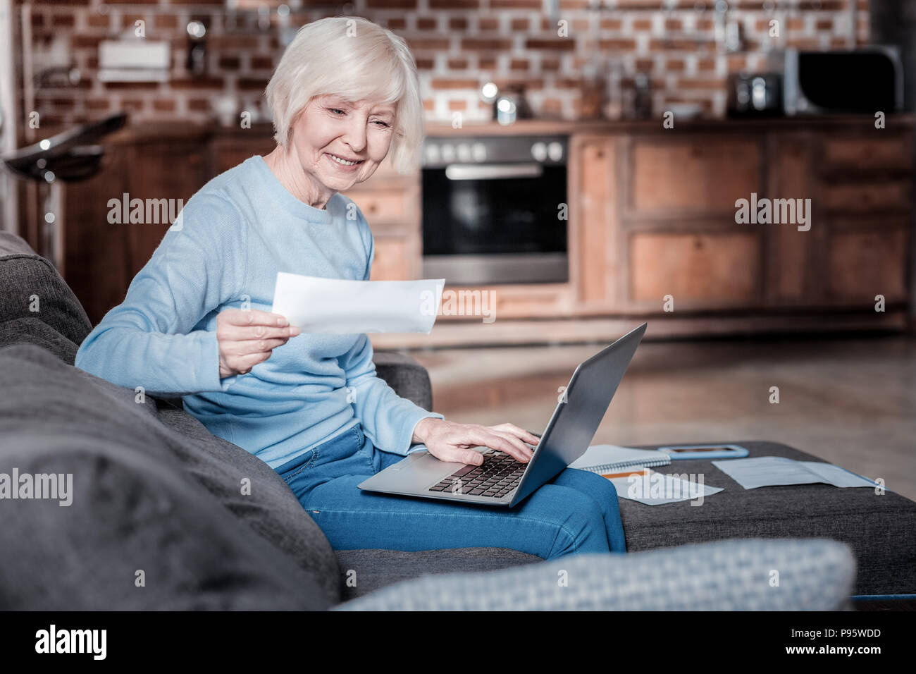 Relaxed mature woman working with computer Stock Photo - Alamy