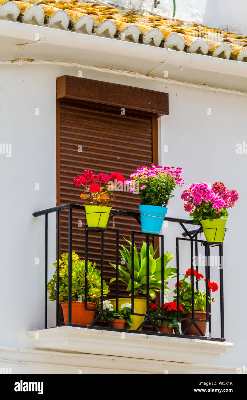 Stylish balcony with a metal railing, solid architectural element, a ...