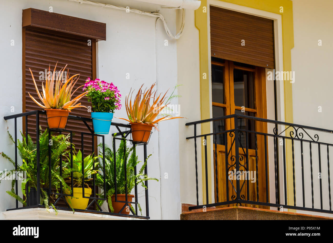 Stylish balcony with a metal railing, solid architectural element, a ...