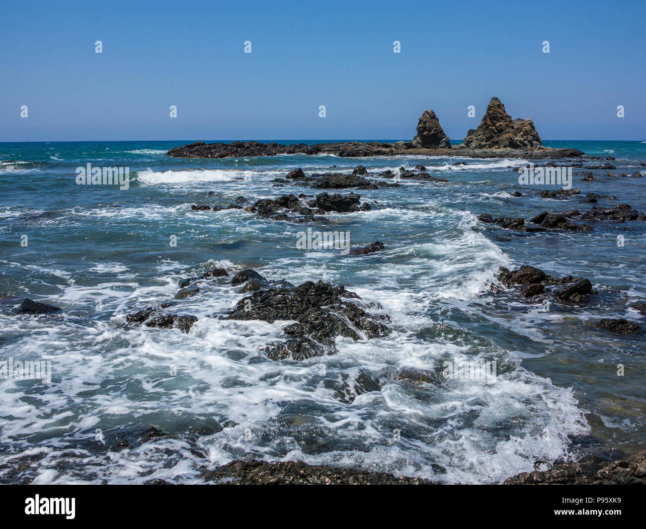 Rough seas hit the jagged rocks of a Cyprus cove Stock Photo - Alamy