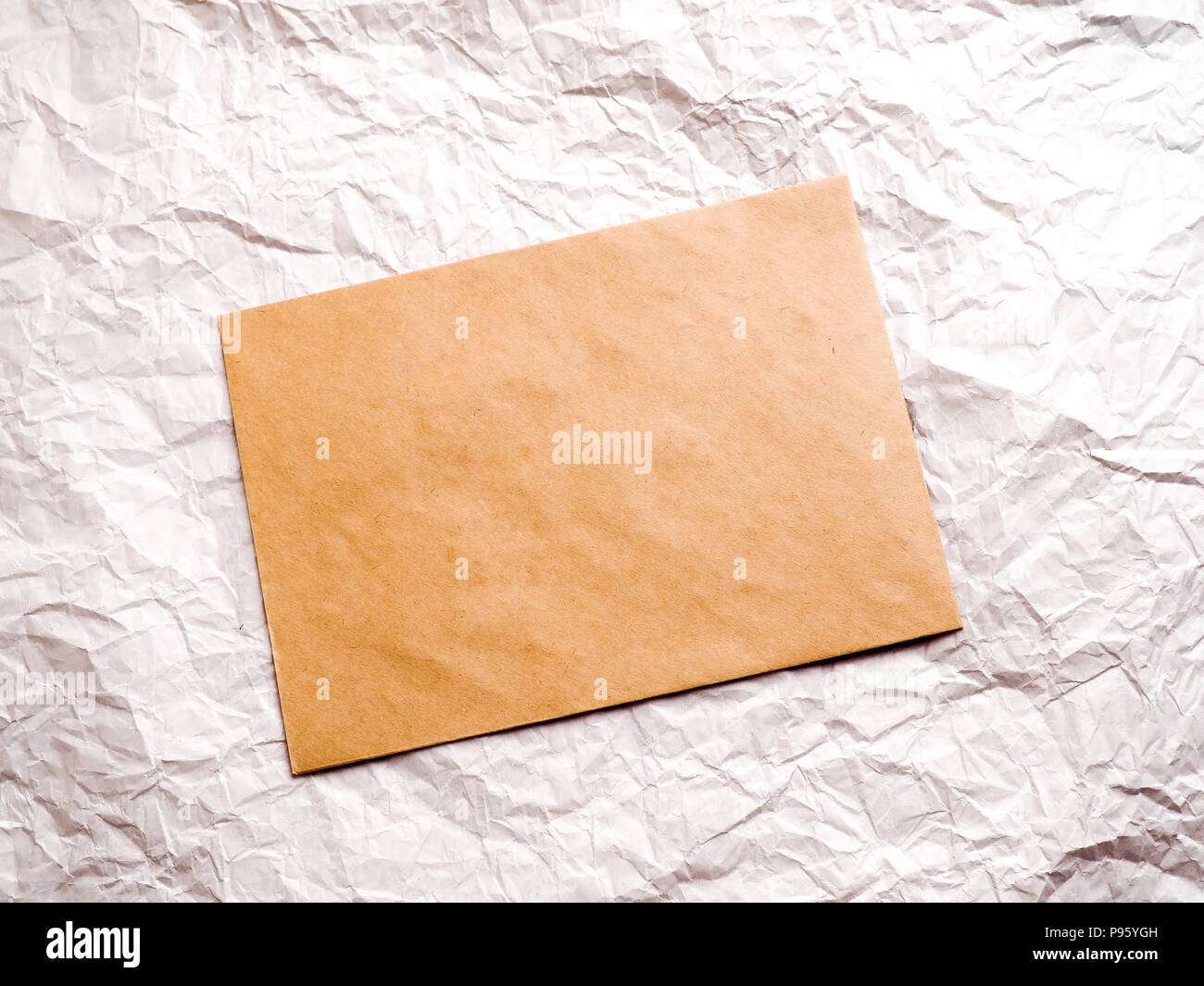envelope of Kraft paper lies on crumpled paper Stock Photo - Alamy
