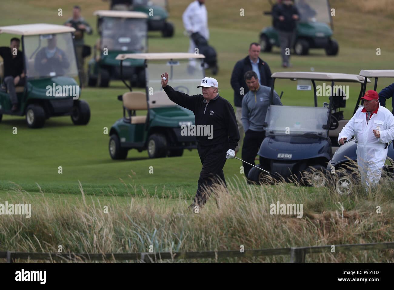US President Donald Trump (centre) on his golf course at the Trump ...