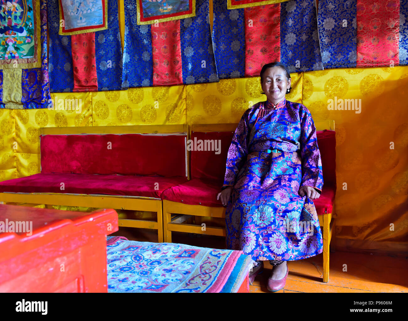 Mongolian woman sitting in the prayer room of the Erdene Khamba ...