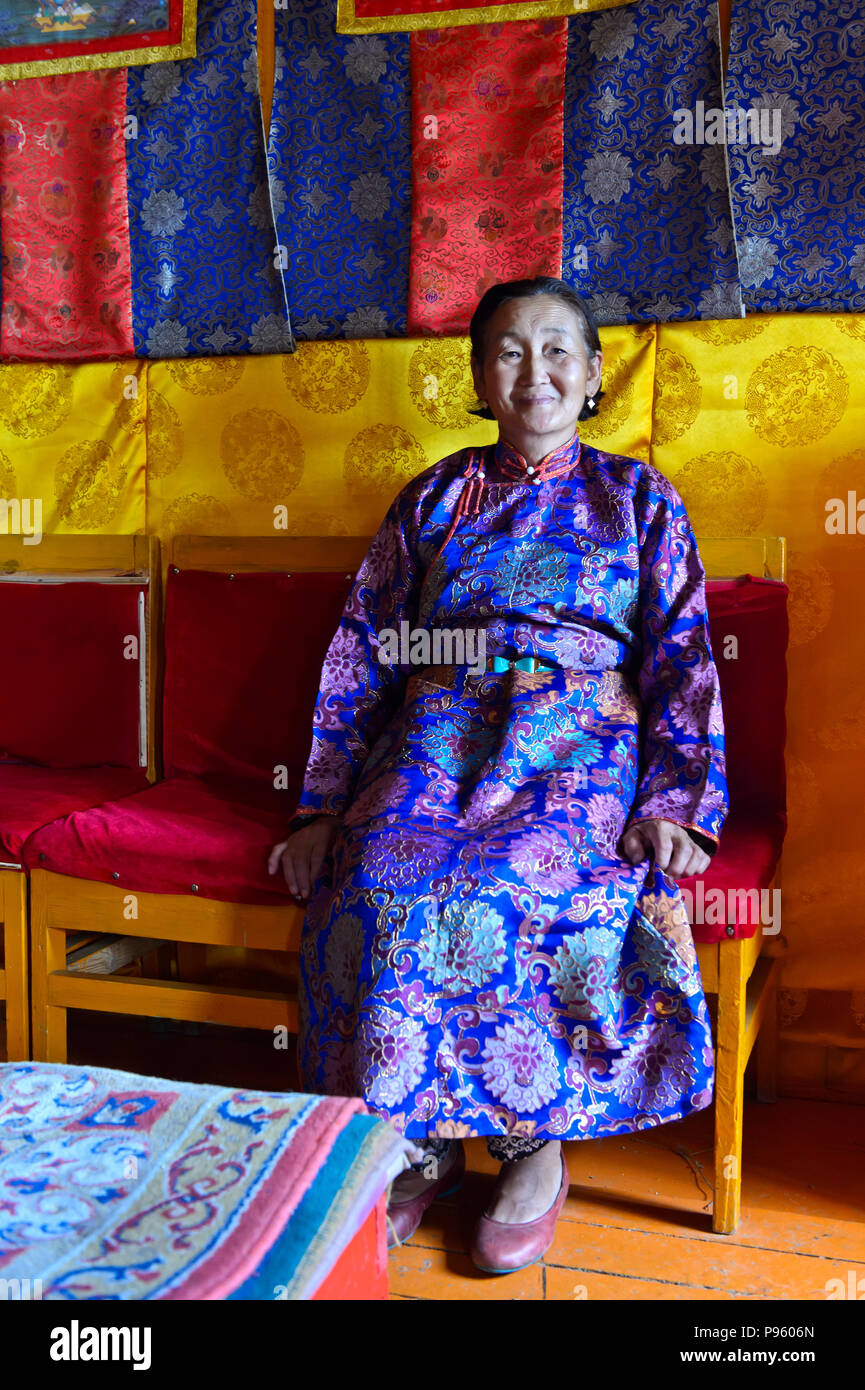 Mongolian woman sitting in the prayer room of the Erdene Khamba ...