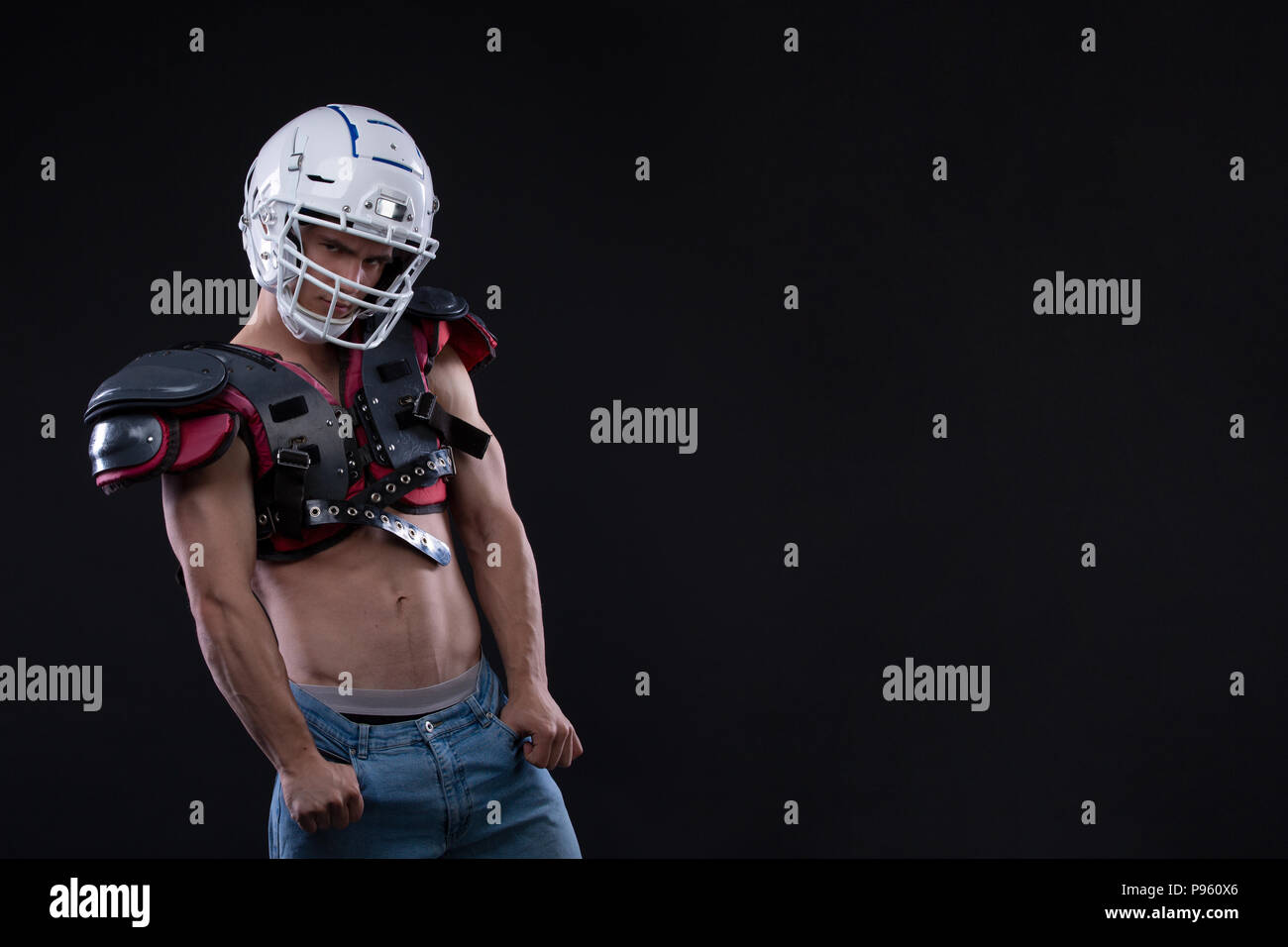 American football player wearing helmet and protective shields on black ...