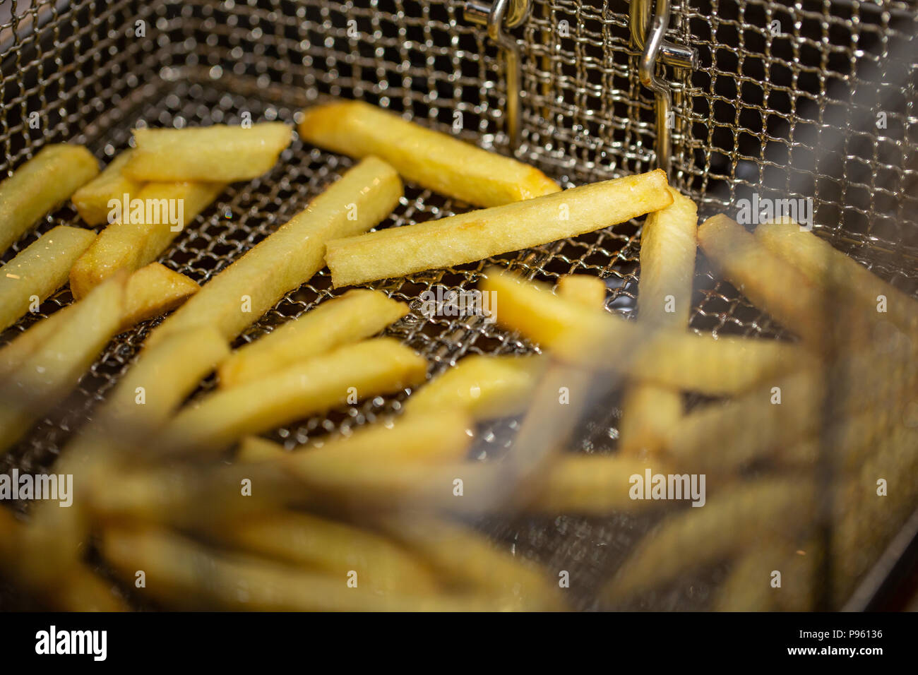 Cooking french fries in a fryer. Macro background Stock Photo - Alamy