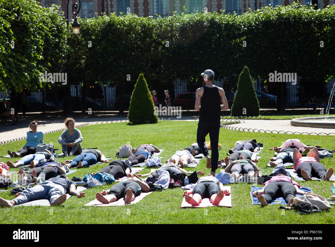 People doing Yoga in Place Des Vosges Park in Paris, France Stock Photo ...
