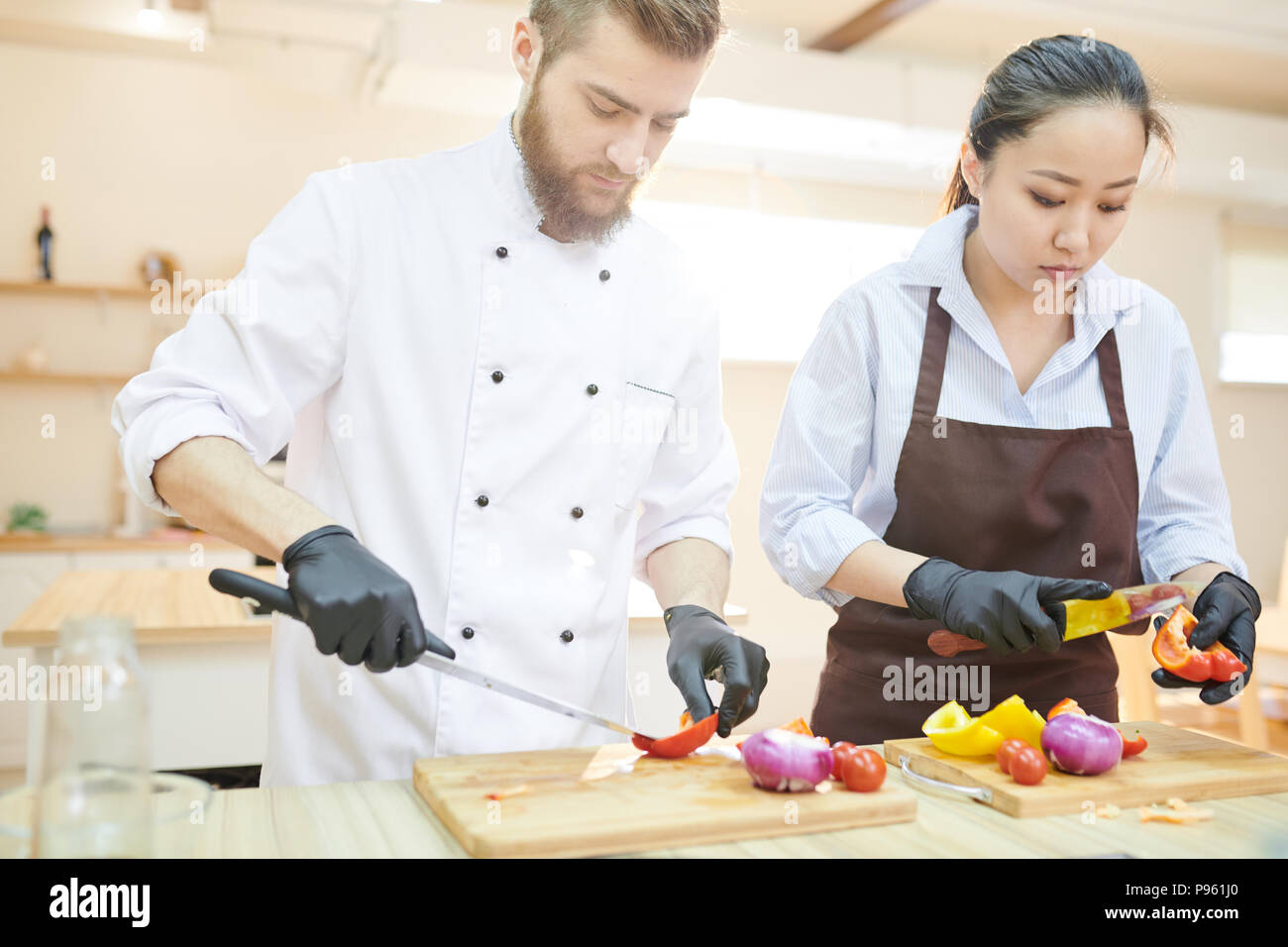Two Modern Chefs Working in Kitchen Stock Photo - Alamy