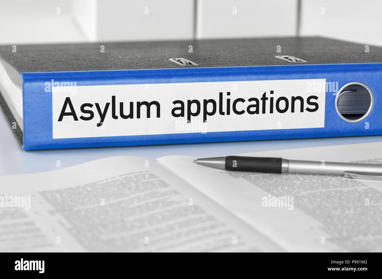 A blue folder with the label Asylum applications Stock Photo - Alamy