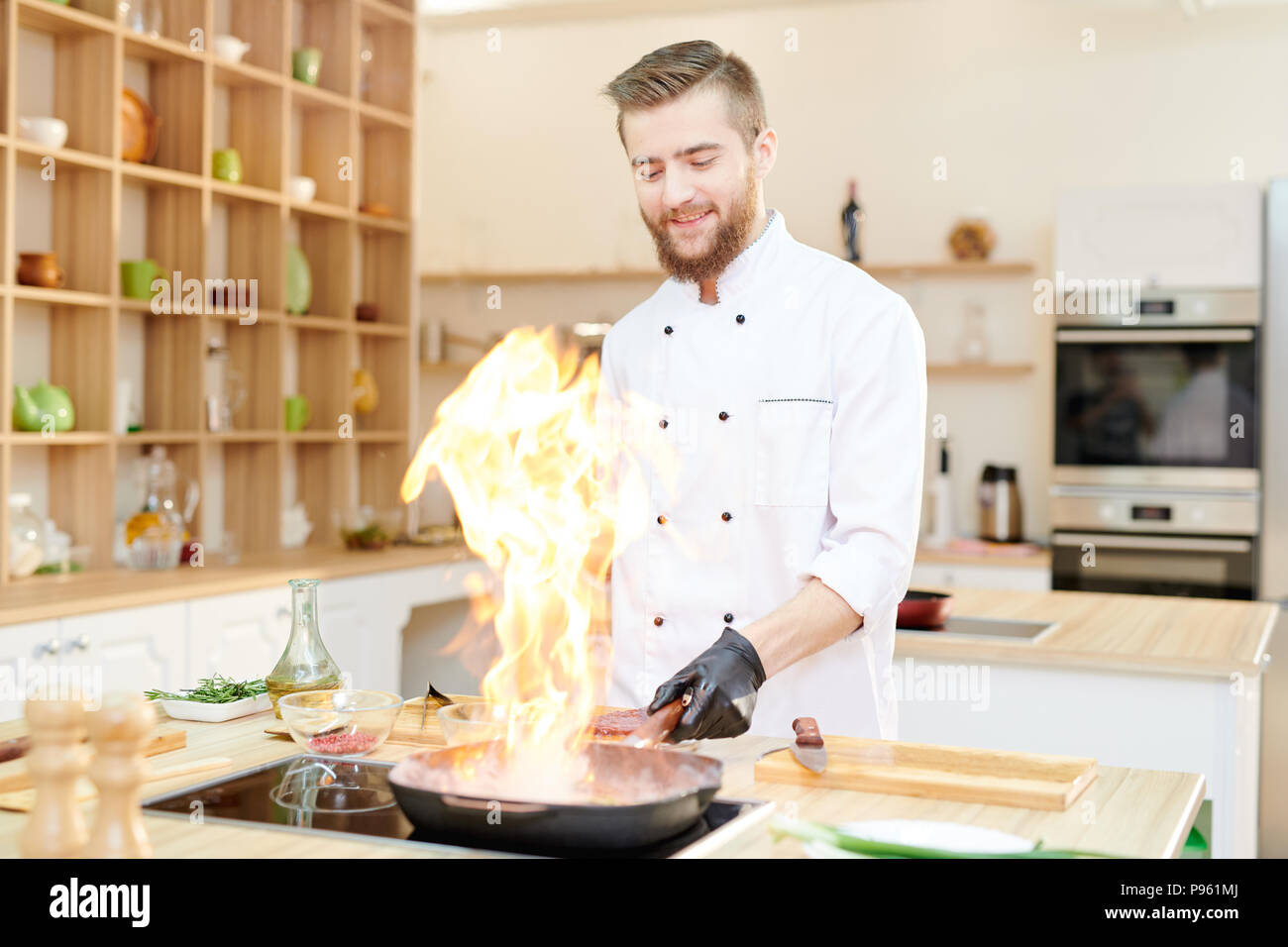 Smiling Chef Cooking Flambe Stock Photo - Alamy