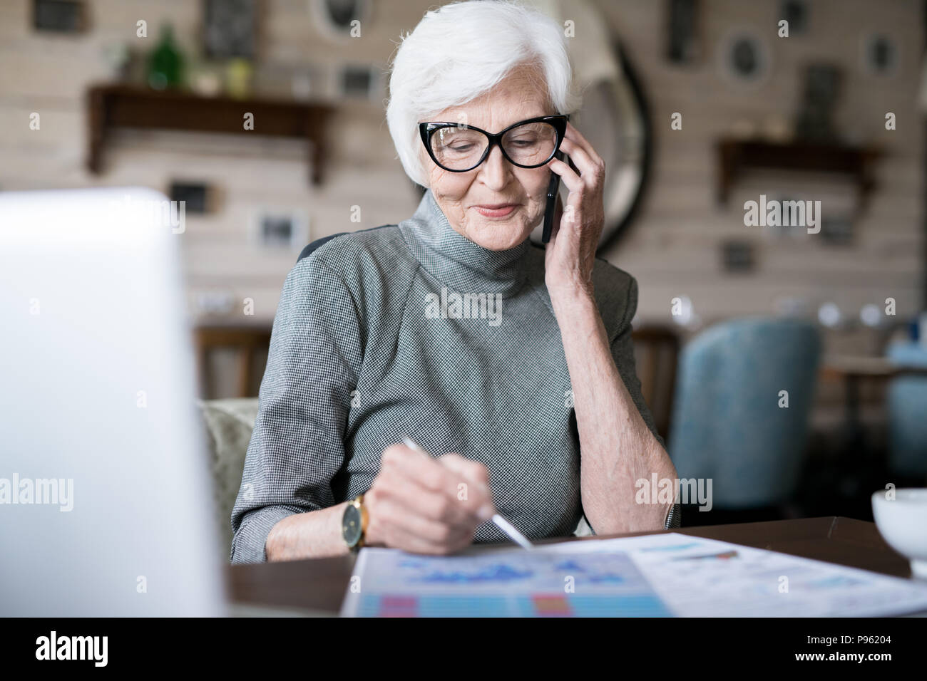 Busy senior woman using phone Stock Photo - Alamy