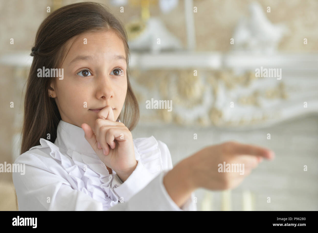 Emotional little girl pointing somewhere at home Stock Photo - Alamy