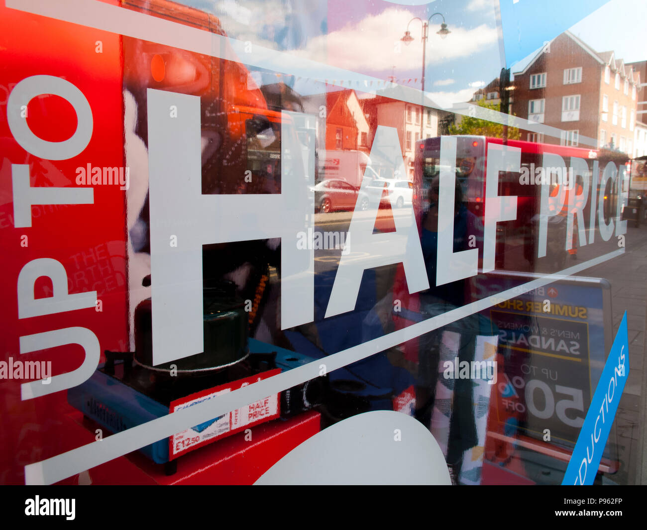 half price sale sign advertising price discounts in clothing shop ...