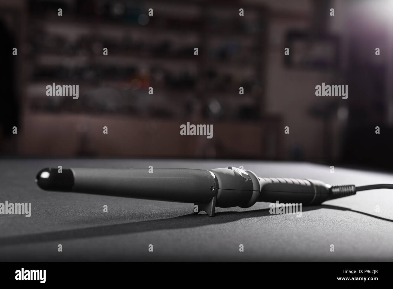 professional hair straightener on a grey table in salon Stock Photo - Alamy