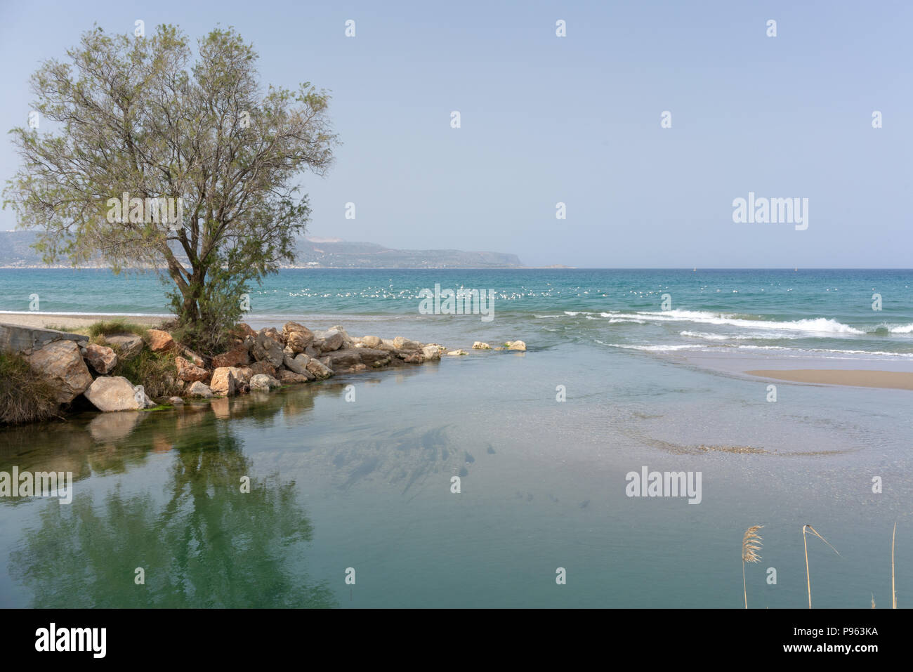 Beach scene with river inlet near Kalives on the island of Crete ...