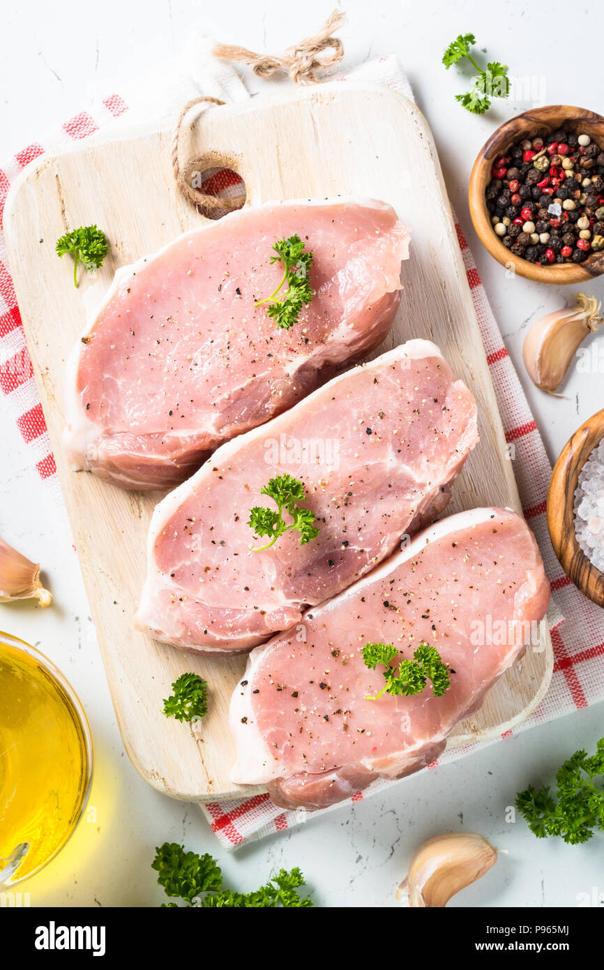 Pork meat steak, slices pork loin on white. Top view, vertical Stock ...