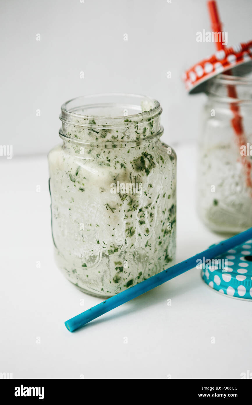 Empty jars with a green cocktail. Conceptual photography. Ending a meal ...