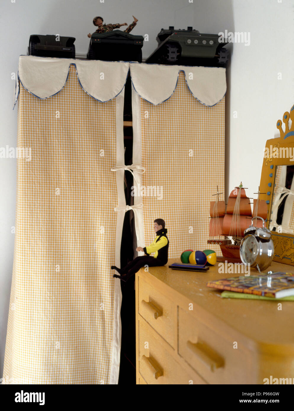 Checked tent effect wardrobe in an economy style nineties bedroom Stock ...