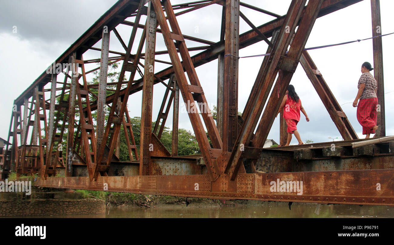 People crossed the unused railway bridge in Baleendah, Bandung ...