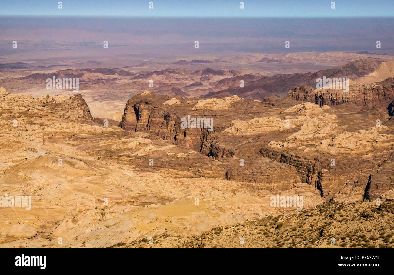 View across barren deseert landscape looking down to Petra valley and ...