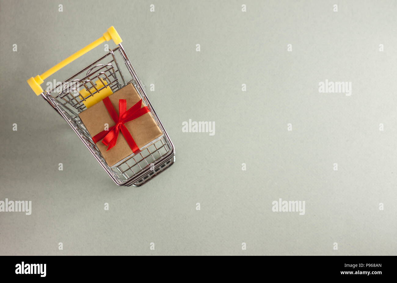 mini shopping cart with boxes with presents Stock Photo - Alamy