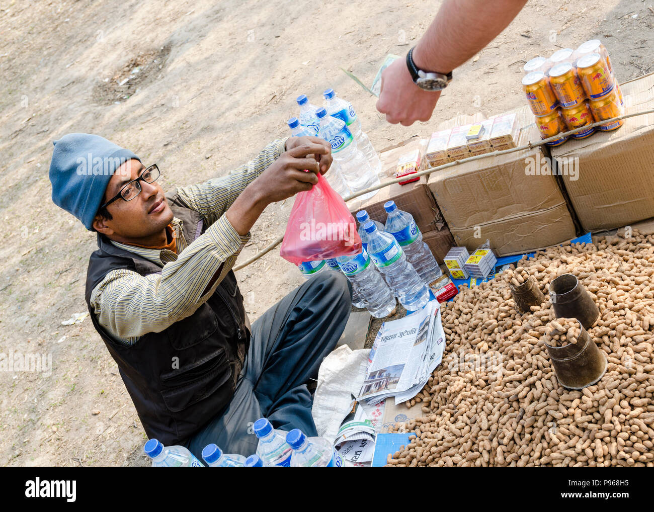 Young Nepali man selling peanuts during Maha Shivaratri in the vicinity ...
