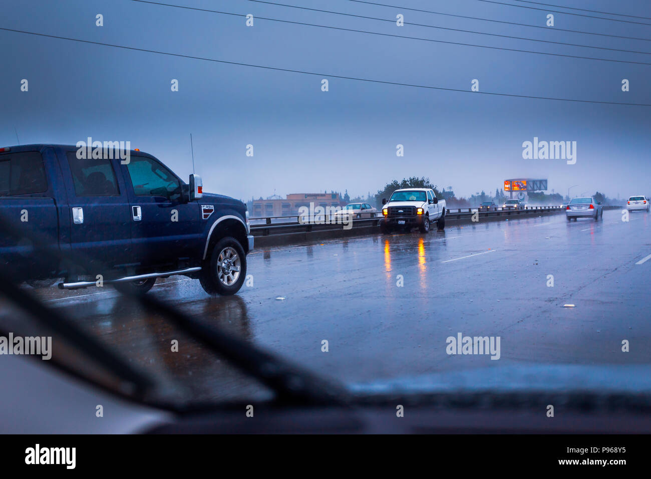 California wet weather driving on the freeway Stock Photo - Alamy