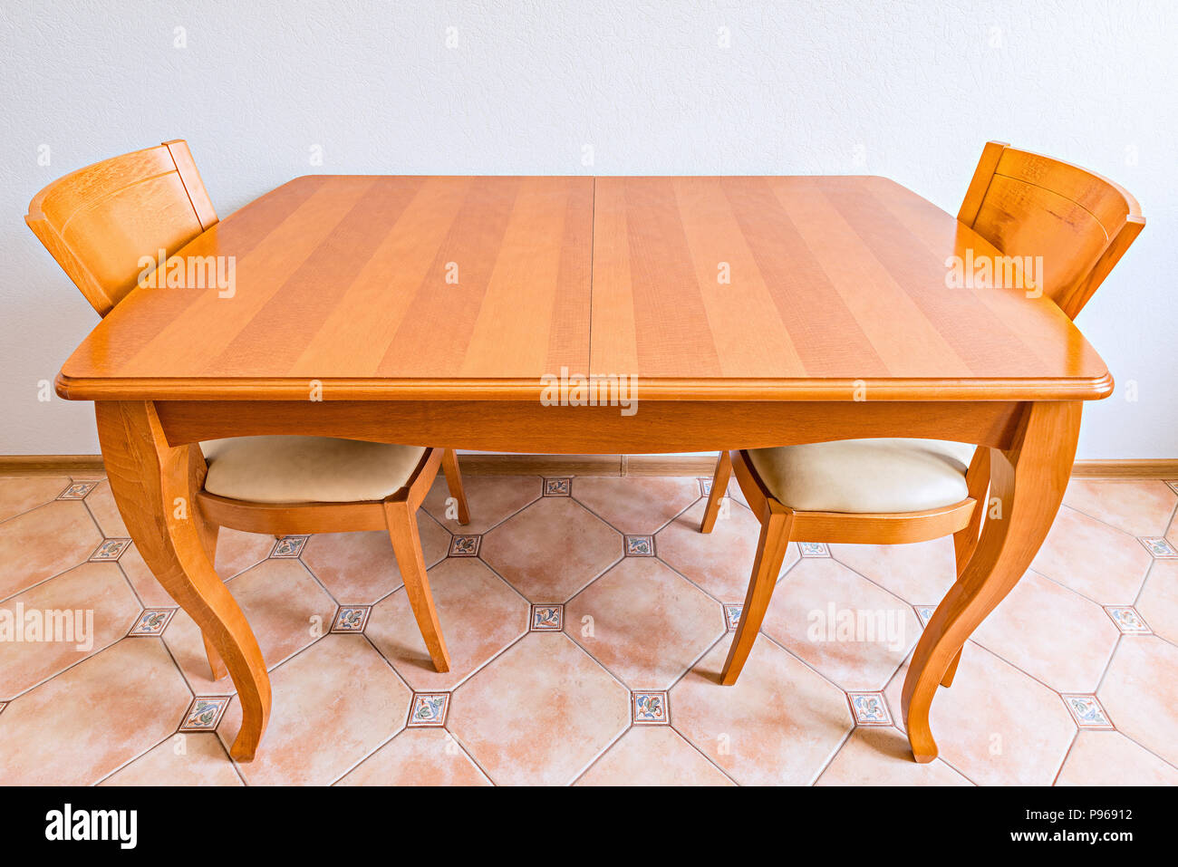 Wooden table and chairs by the wall in the room Stock Photo - Alamy