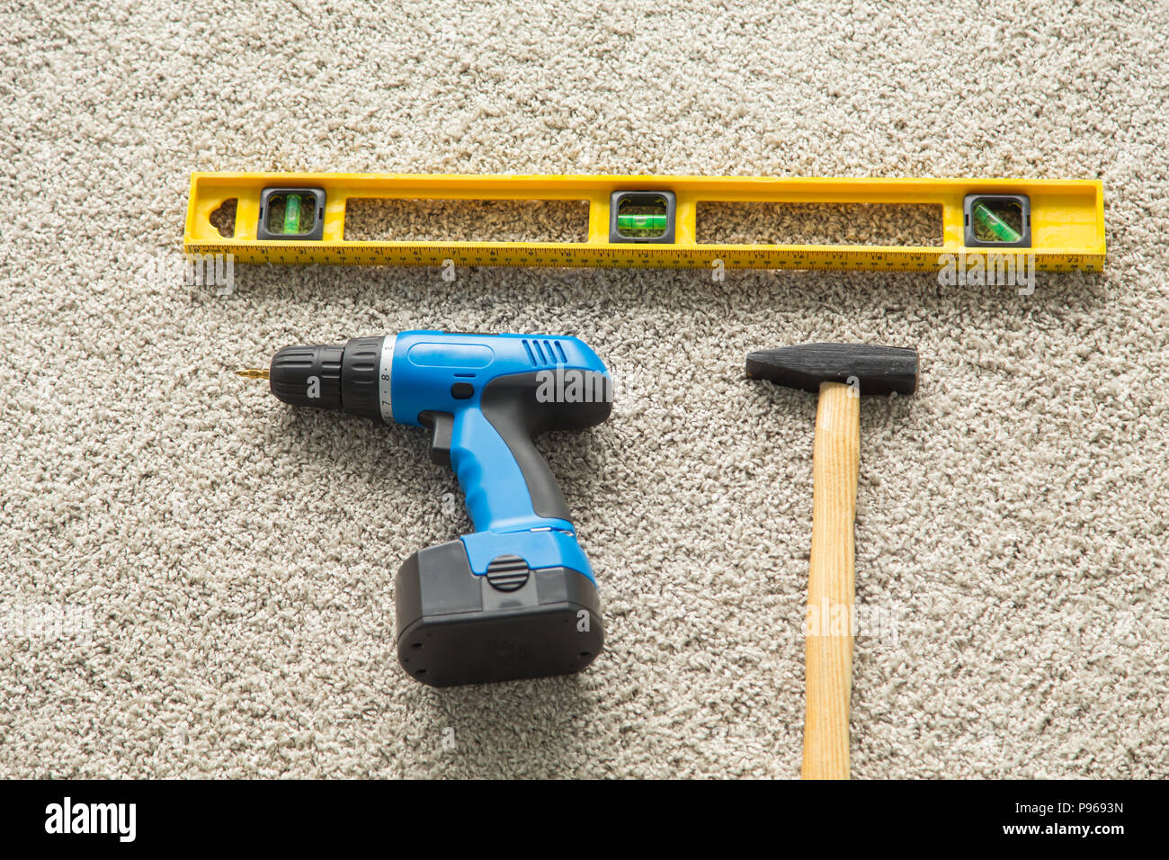 Construction concept - Hammer, drill and builders level on the floor ...