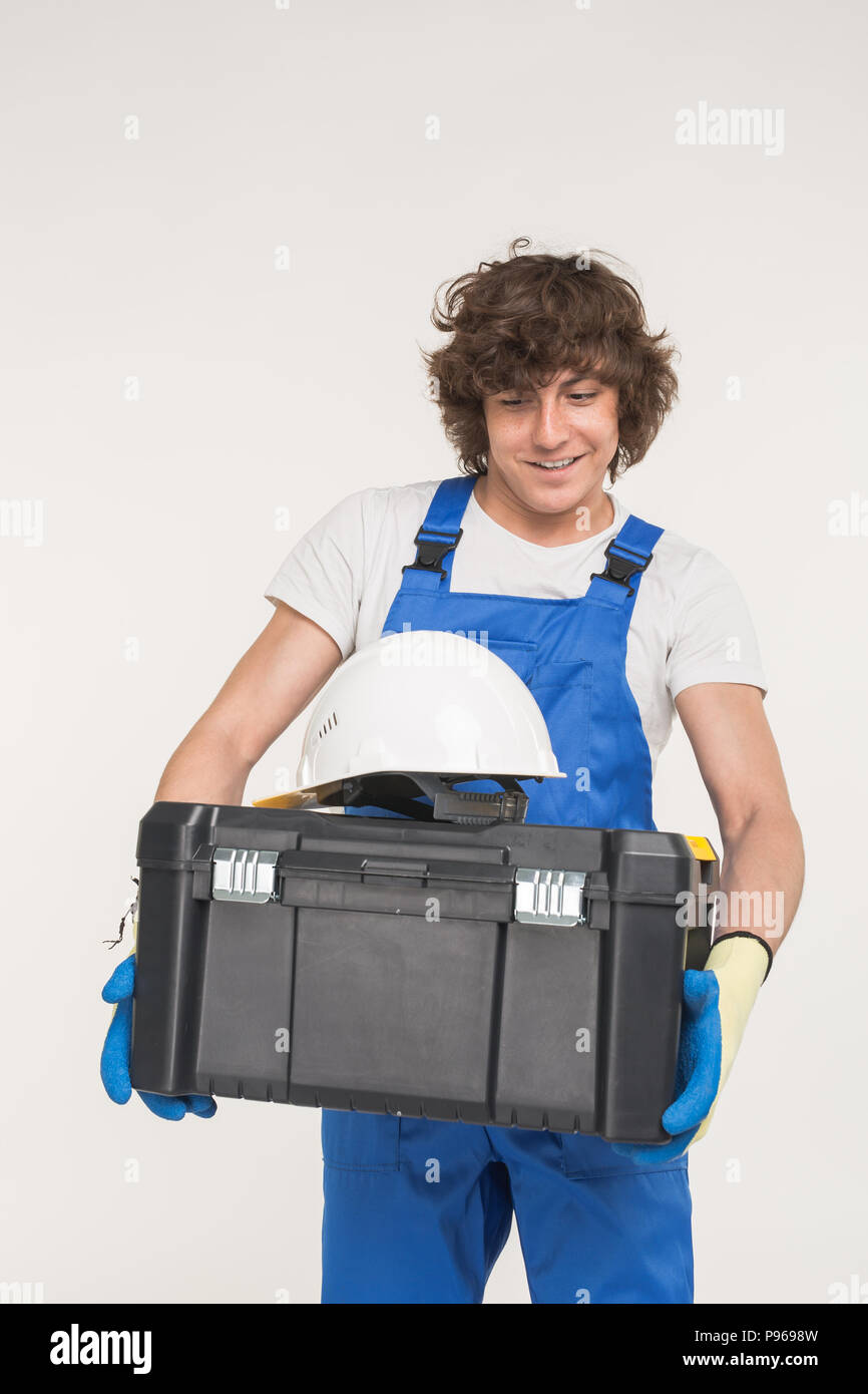 Portrait of handsome caucasian man holding toolbox Stock Photo - Alamy
