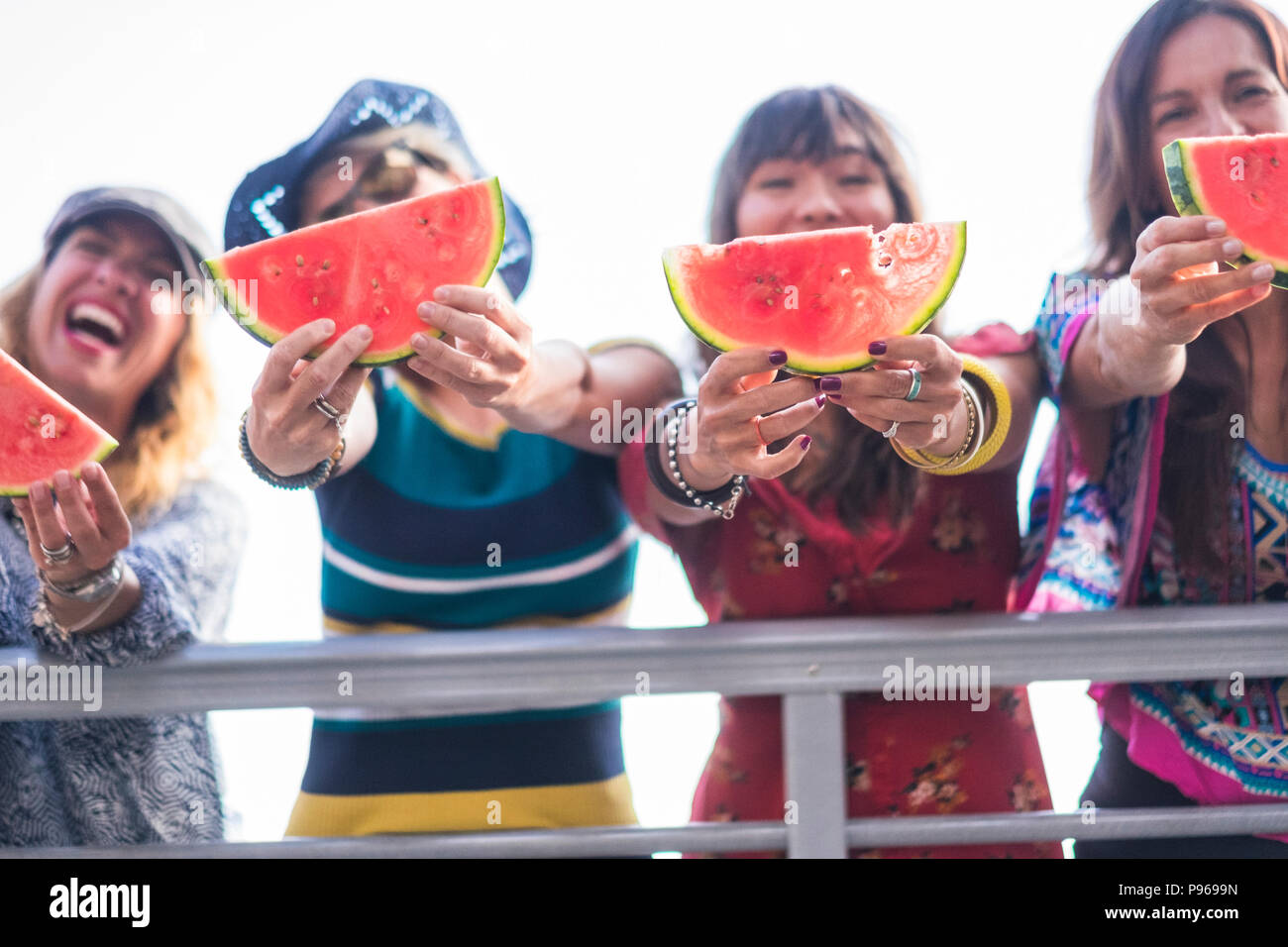 four nice happy young females caucasian eating watermelon to celebrate ...