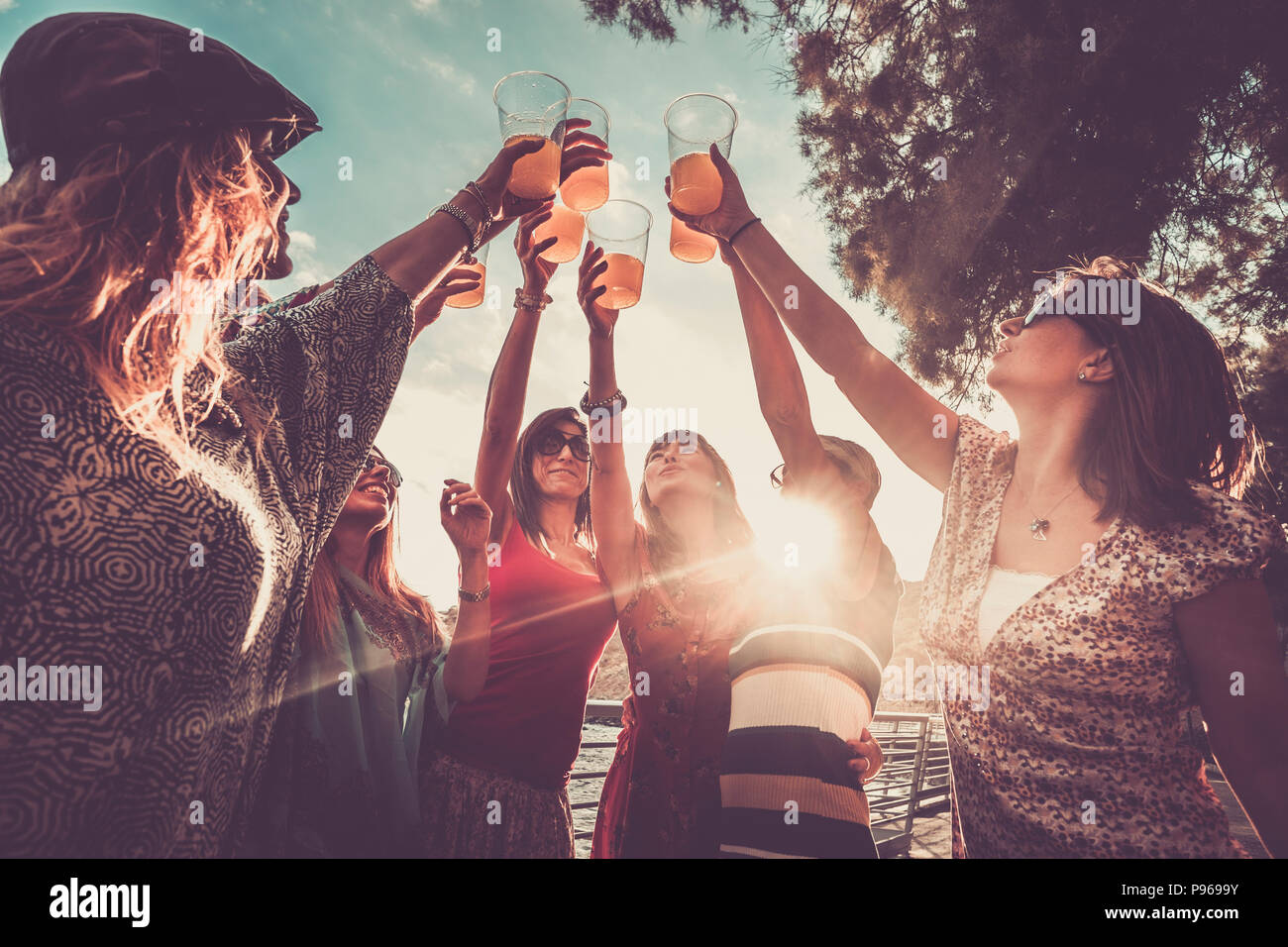 celebrating friendship or success team works outdoor with colored juice ...