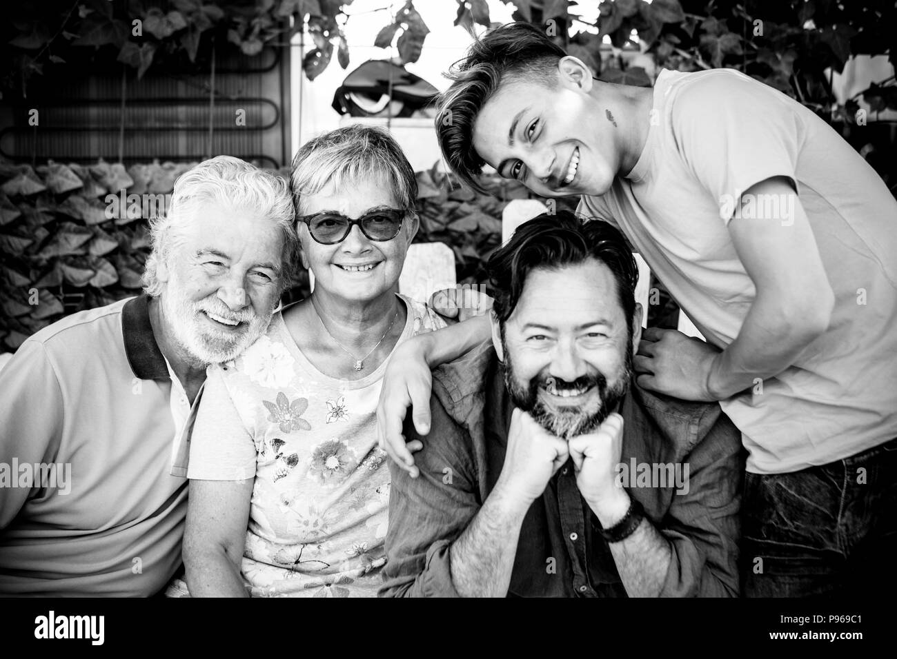 four different mixed generations grandfather father son all together in ...