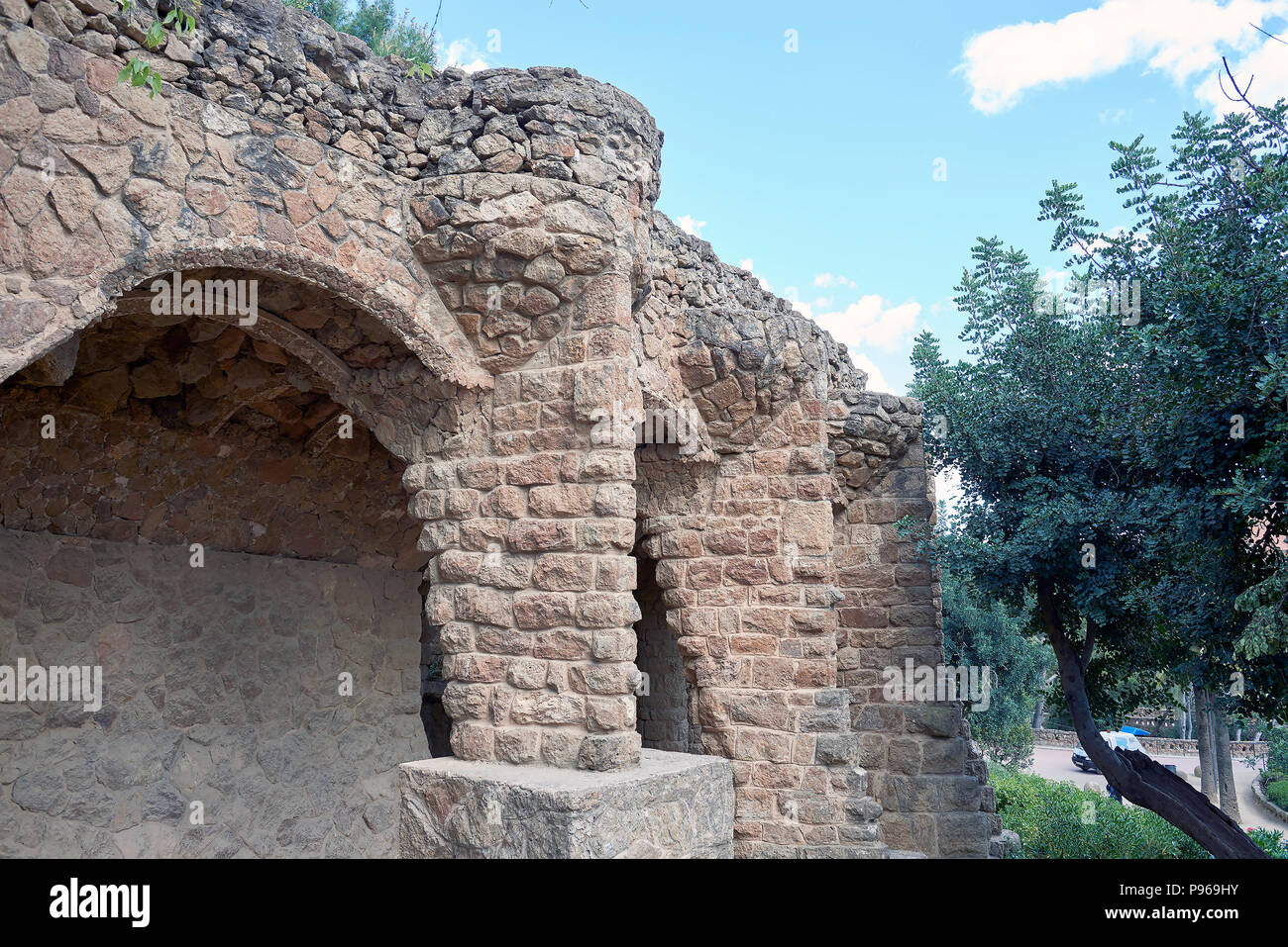 Detail of a stone walkway formed by arches in the Park Guell, made by ...