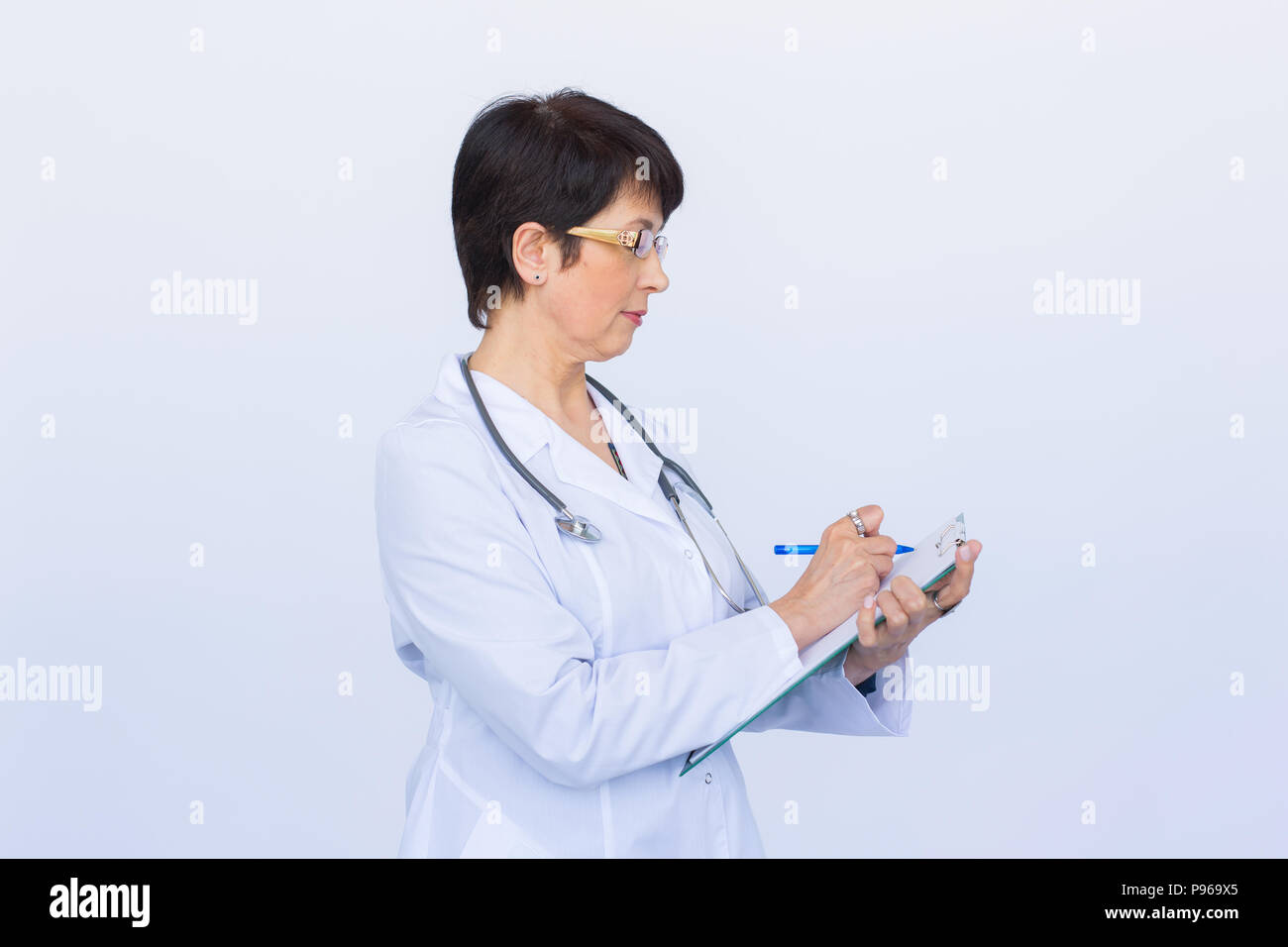 Medical doctor writing prescription over white background Stock Photo ...