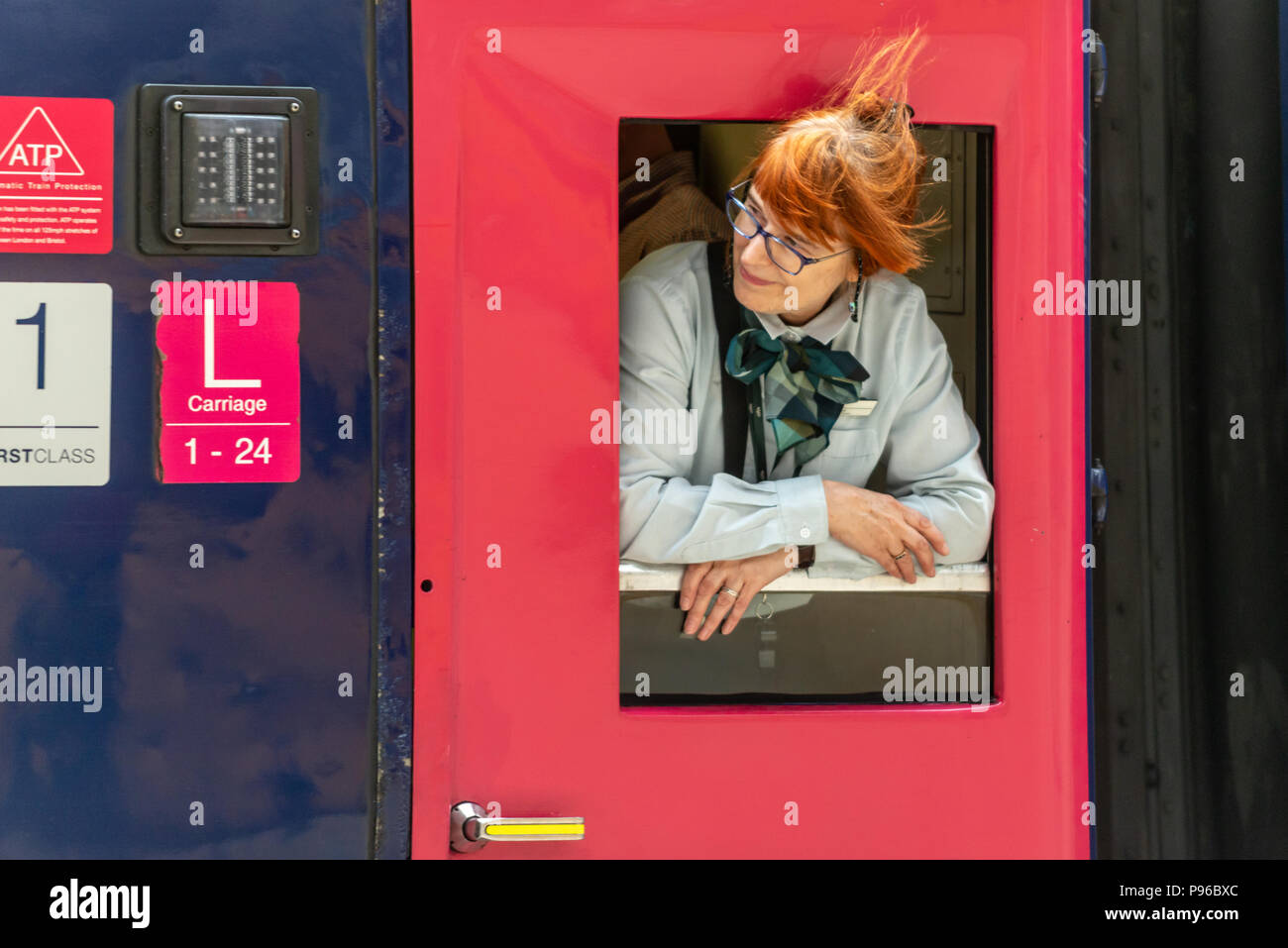 Train conductor at Paddington Station in London Stock Photo - Alamy